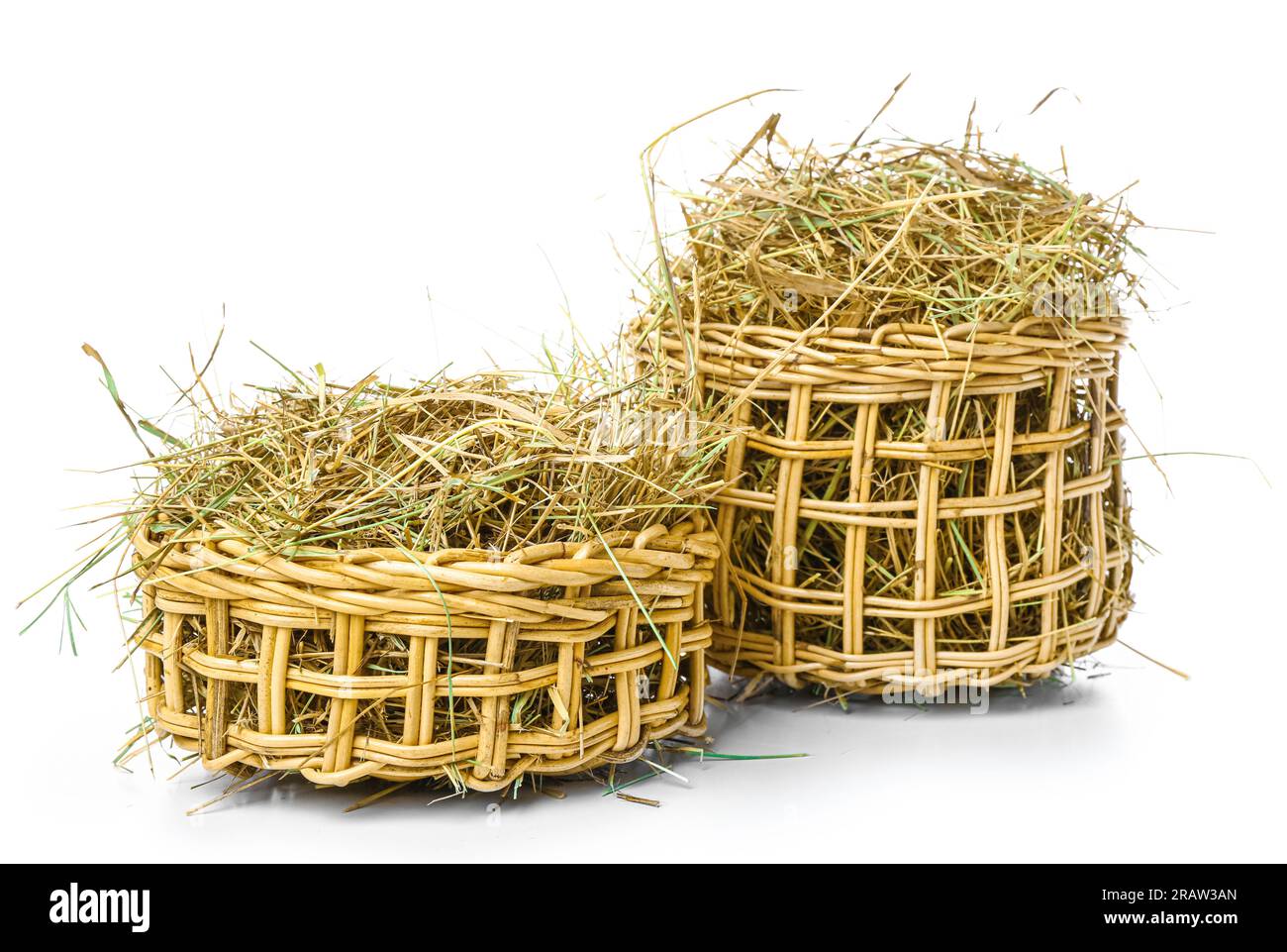 Straw in baskets on white background Stock Photo - Alamy
