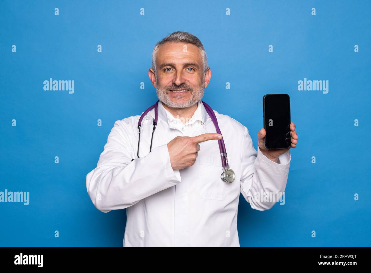 Call the doctor. Middle aged doctor is pointing to the phone standing ...