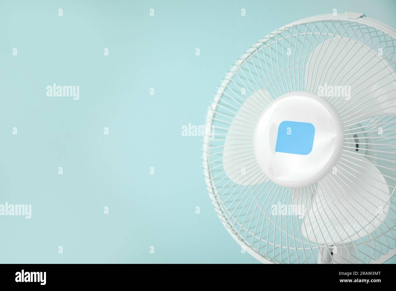 Modern electric fan on blue background Stock Photo - Alamy