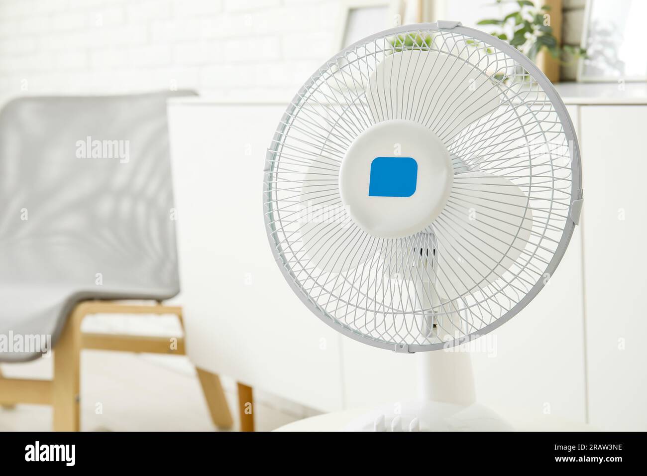 Modern electric fan on table in interior of living room Stock Photo - Alamy