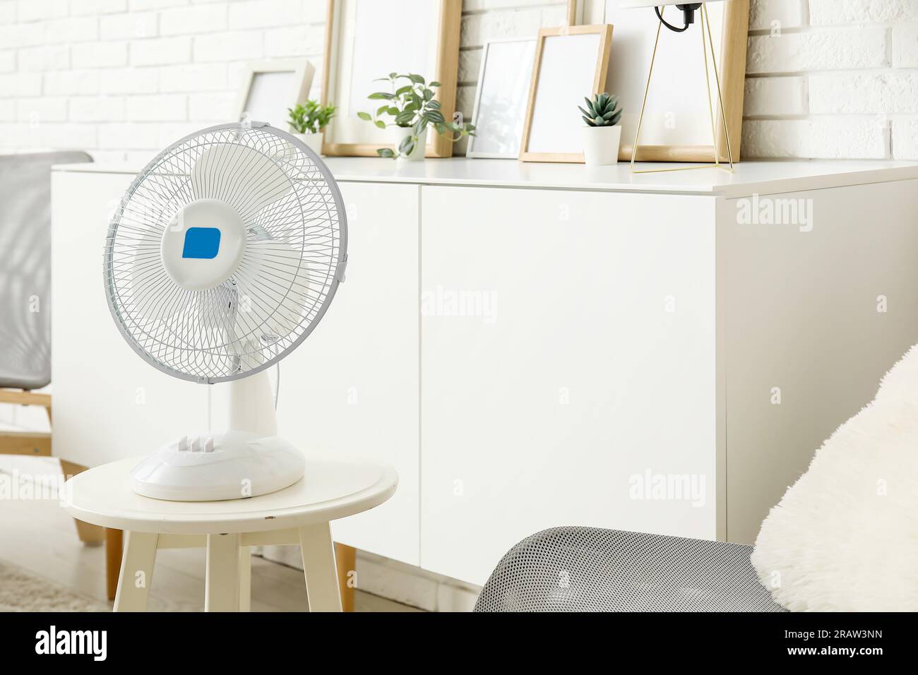 Modern electric fan on table in interior of living room Stock Photo - Alamy