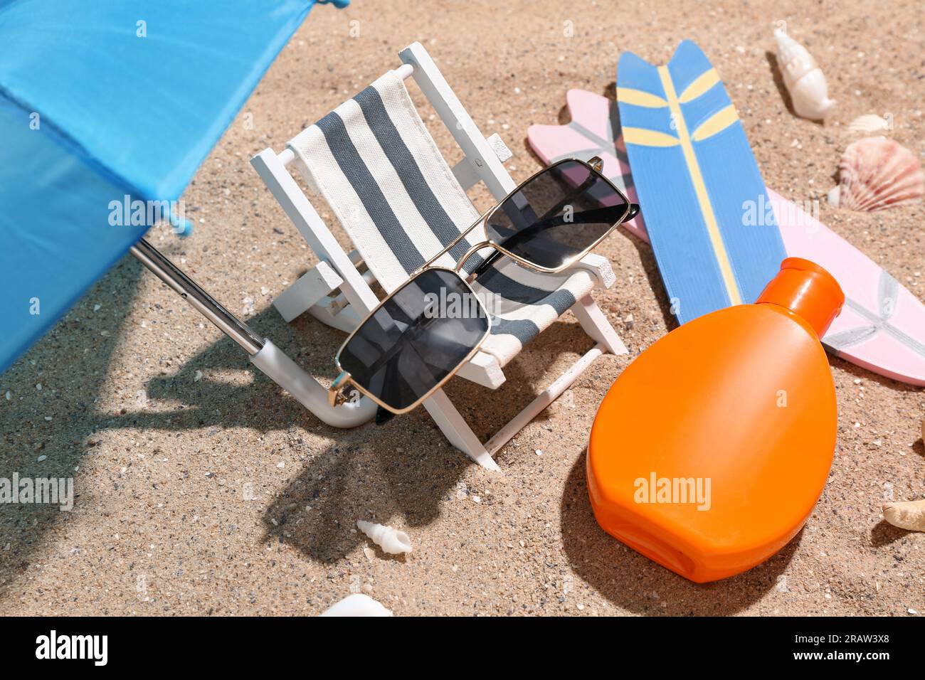 Creative composition with sunglasses, bottle of sunscreen cream, mini ...
