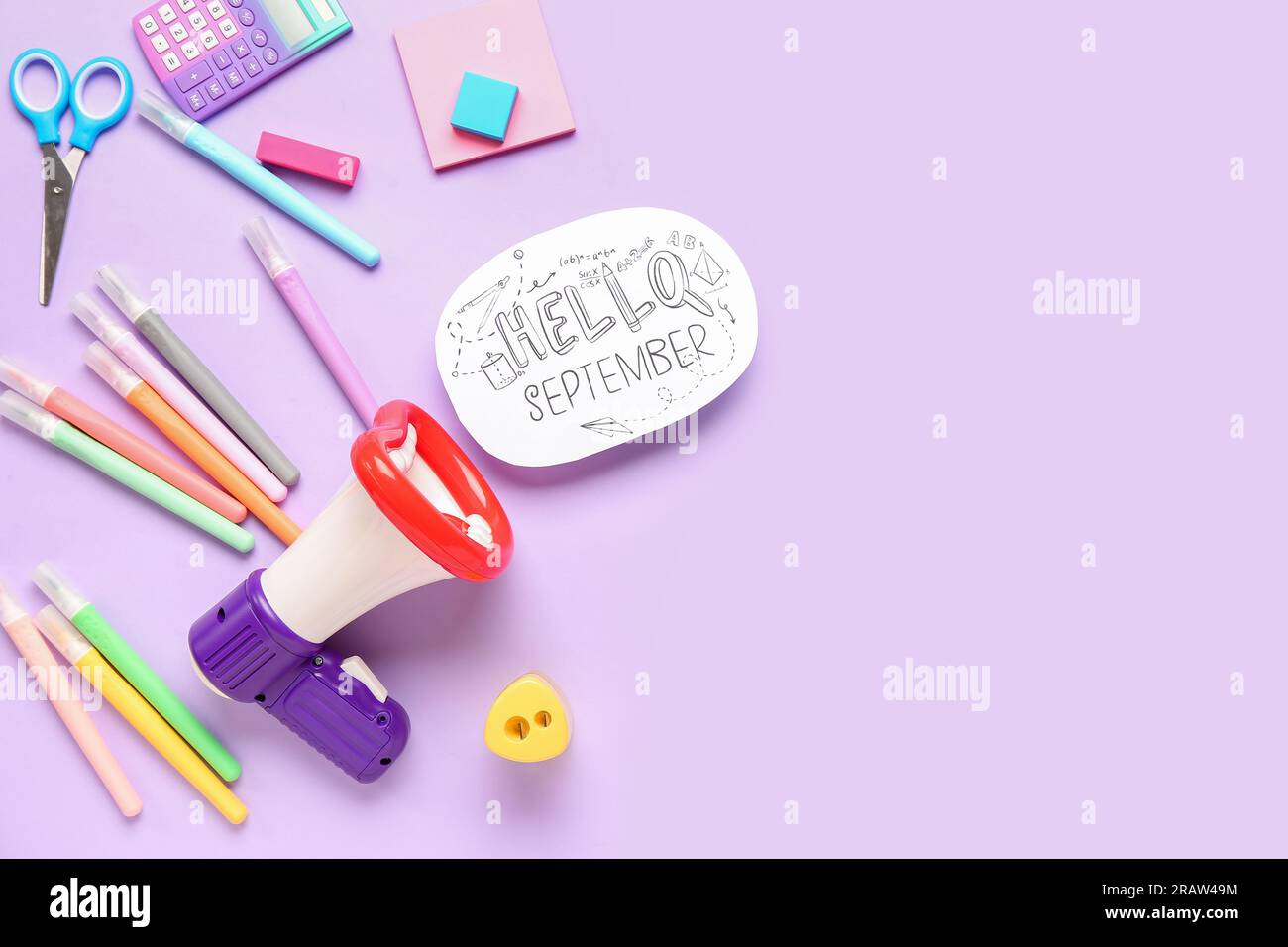 Stationery, megaphone and sheet with text HELLO SEPTEMBER on lilac ...