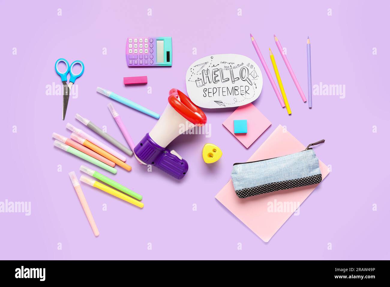 Stationery, megaphone and sheet with text HELLO SEPTEMBER on lilac ...