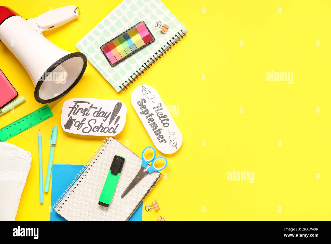 Stationery, megaphone, sheets with text HELLO SEPTEMBER and FIRST DAY ...