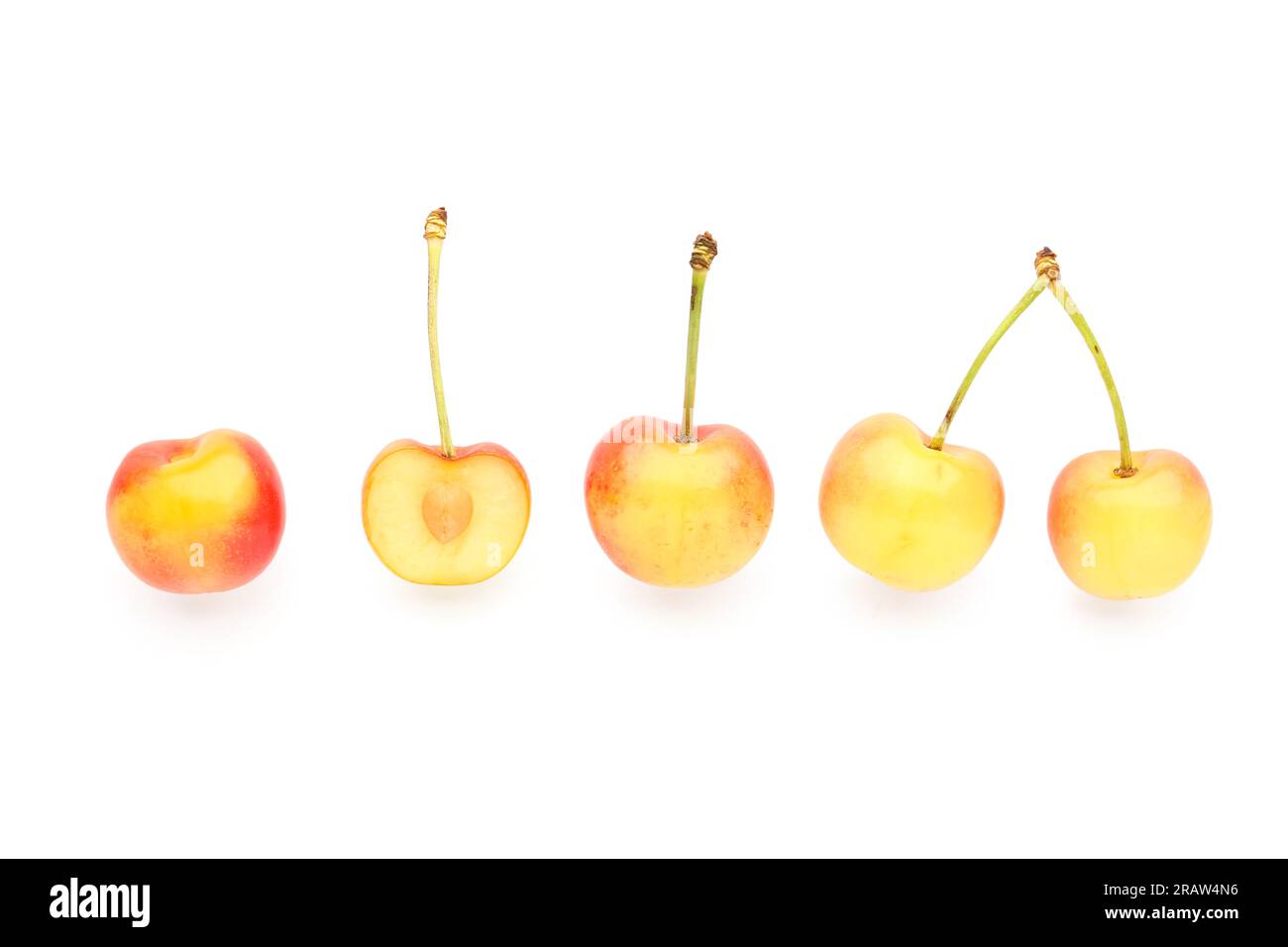 Sweet yellow cherries with half on white background Stock Photo - Alamy