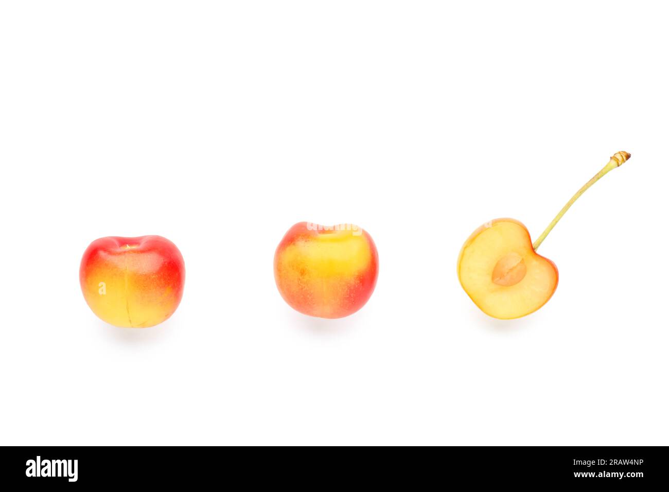 Sweet yellow cherries with half on white background Stock Photo - Alamy