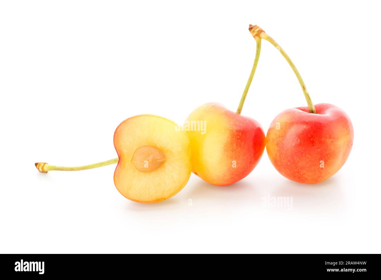 Sweet yellow cherries with half on white background Stock Photo - Alamy