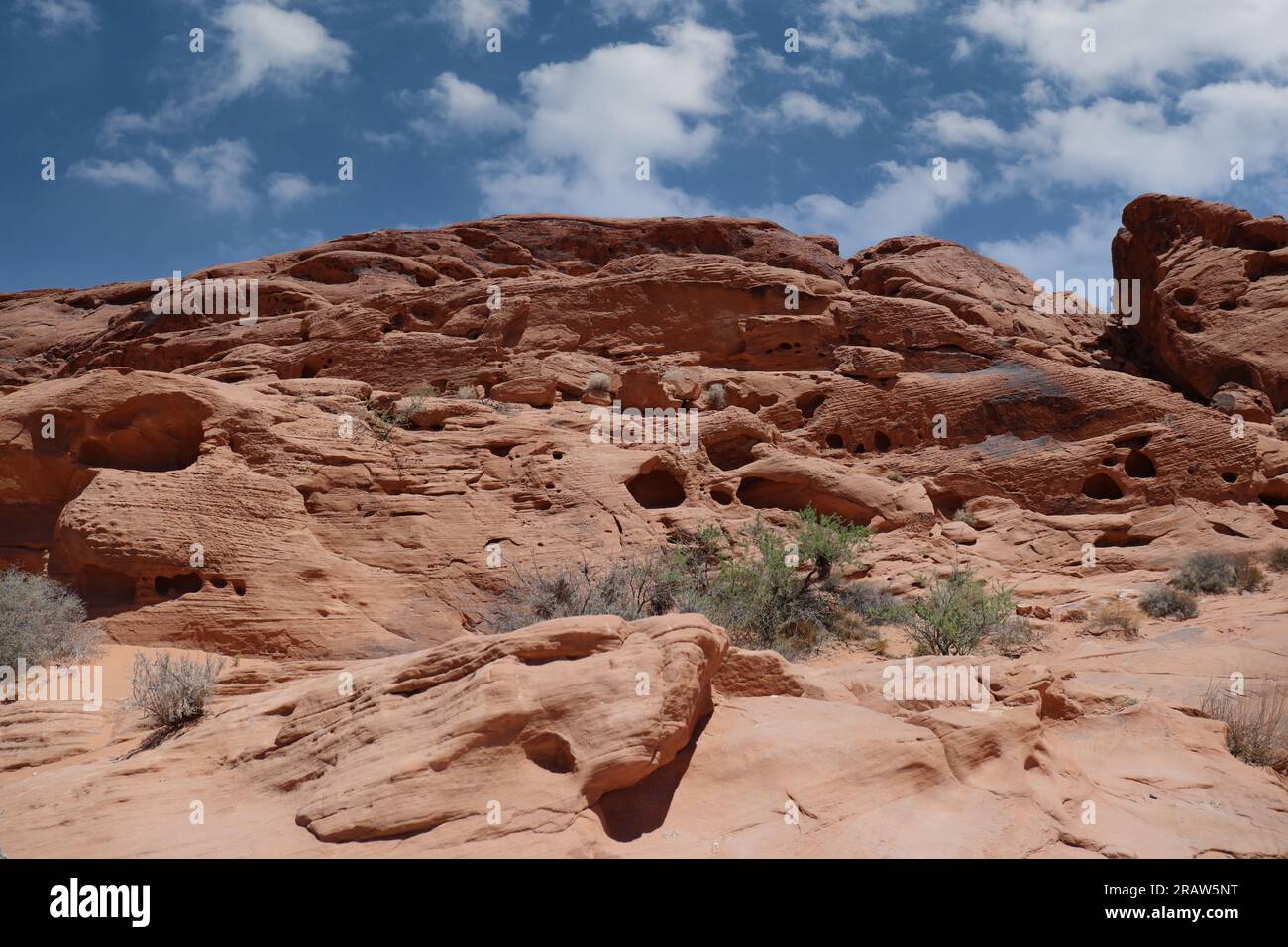 A large, red Aztec sandstone rock formation on the Mouse's Tank trail ...