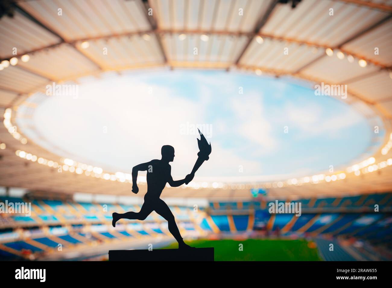 Silhouette of Male Athlete Carrying the Torch Relay, Illuminating the ...