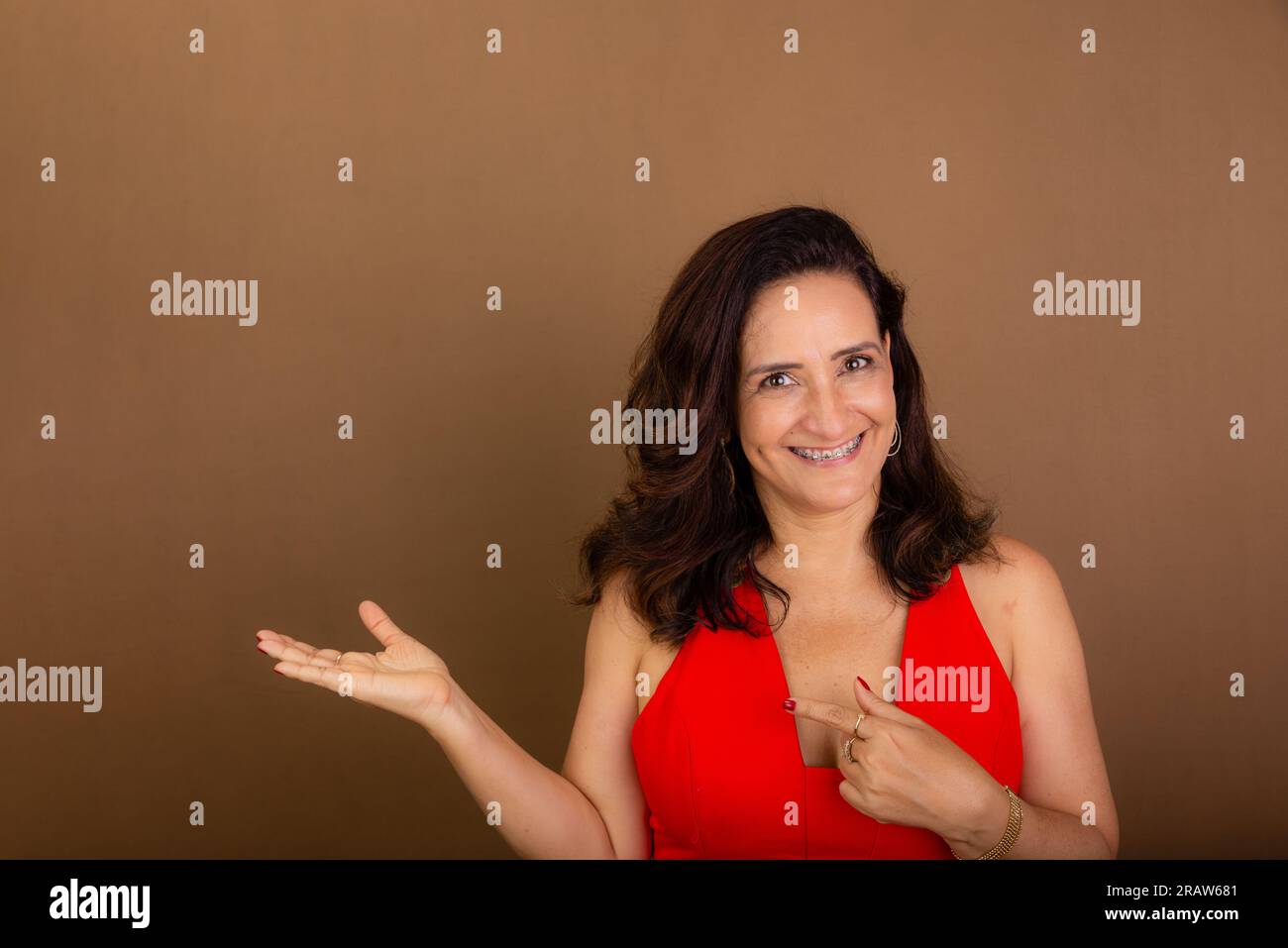 Portrait of beautiful confident cheerful woman making hand gestures ...