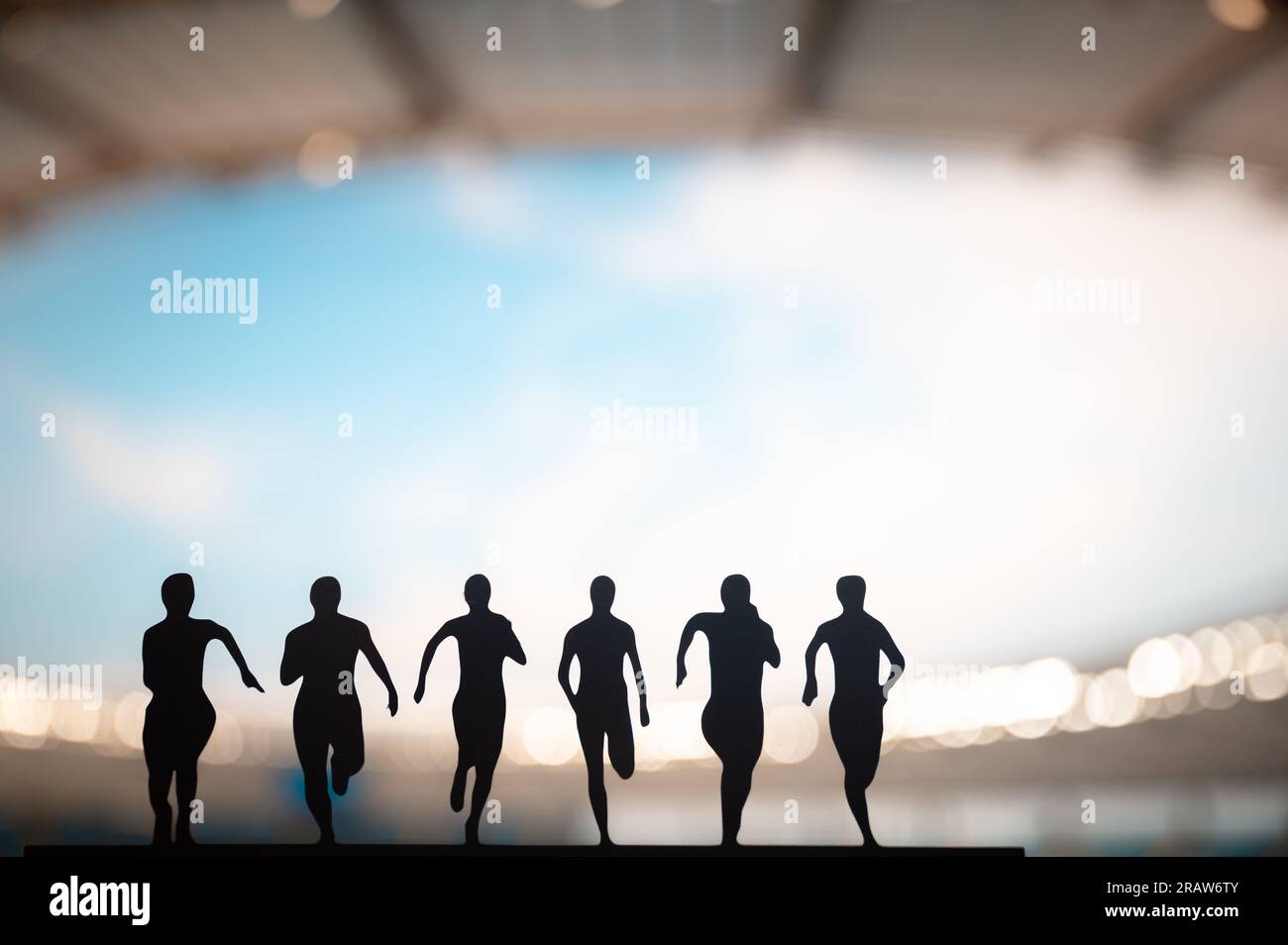 Racing Towards Glory: Silhouette of Sprinters Bolting Across the Track ...
