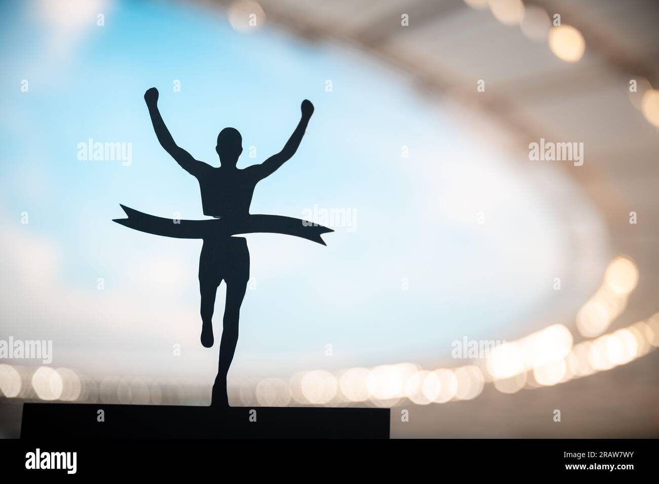 Exhilarating Finish: Silhouetted Runner Claims Victory at Modern ...