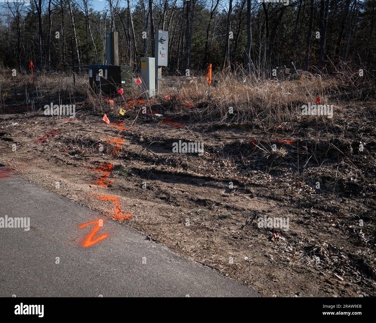 Warning caution flags and orange paint marking underground utility ...