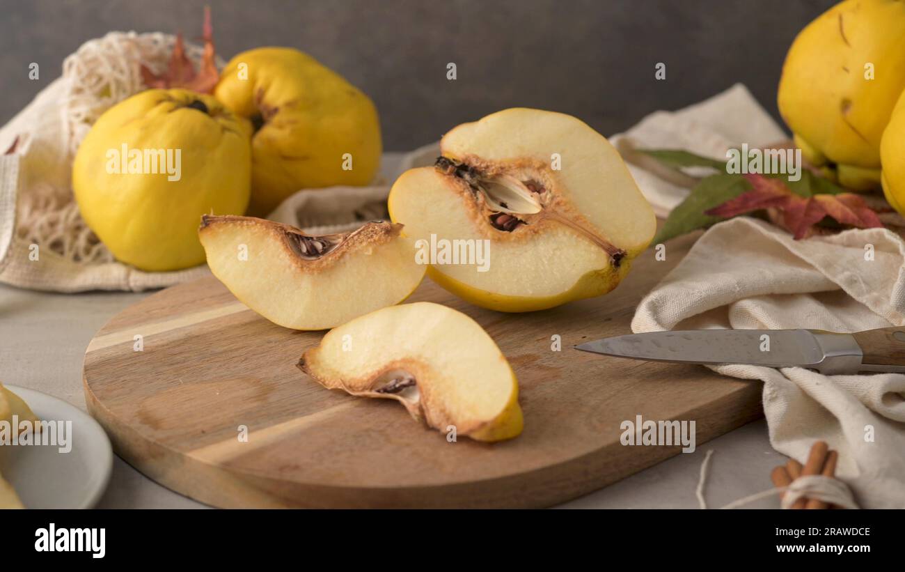 Ripe yellow quinces or queen apple fruits and sliced quince halves with ...