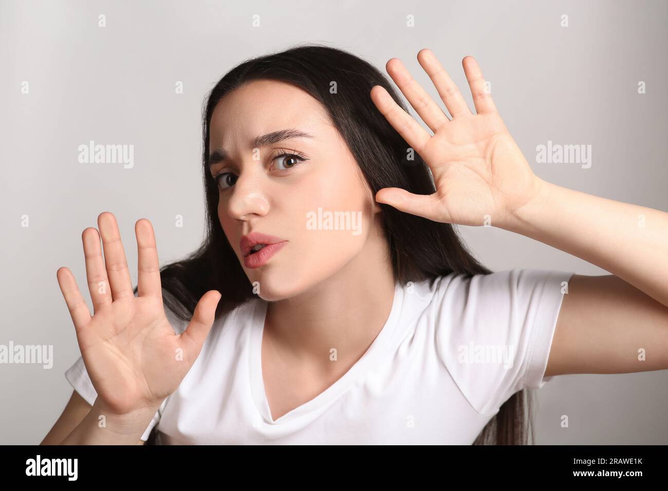 Shocked young woman stuck to transparent screen. Internet addiction ...