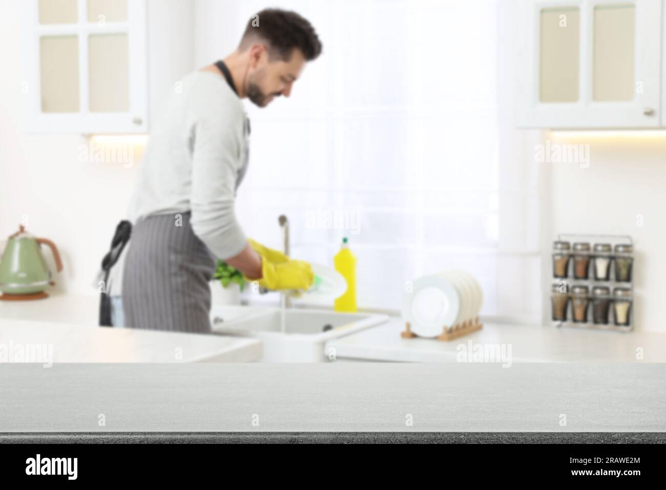 Man doing washing up in kitchen, focus on empty grey stone table Stock ...