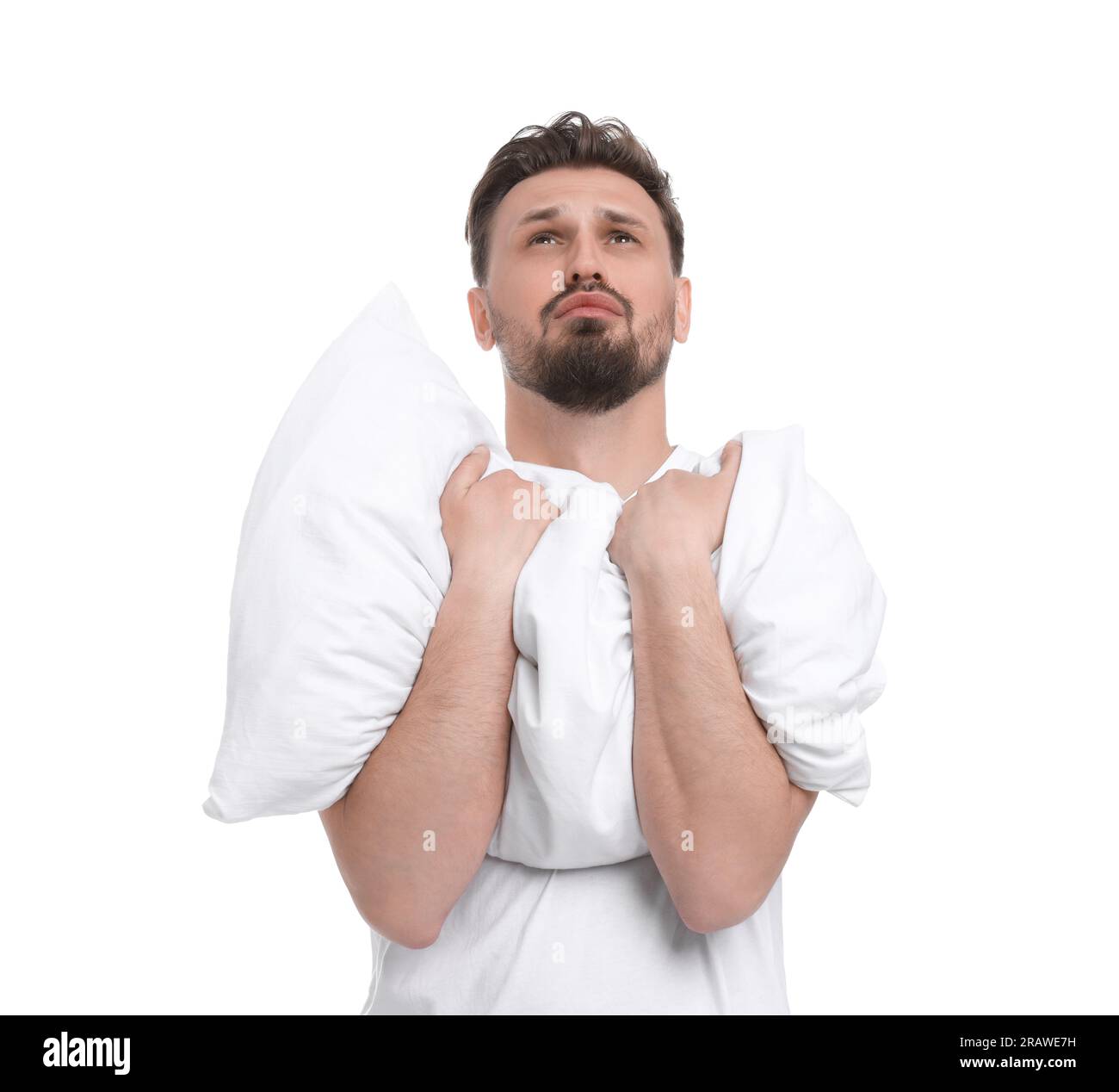 Unhappy man with pillow on white background. Insomnia problem Stock ...
