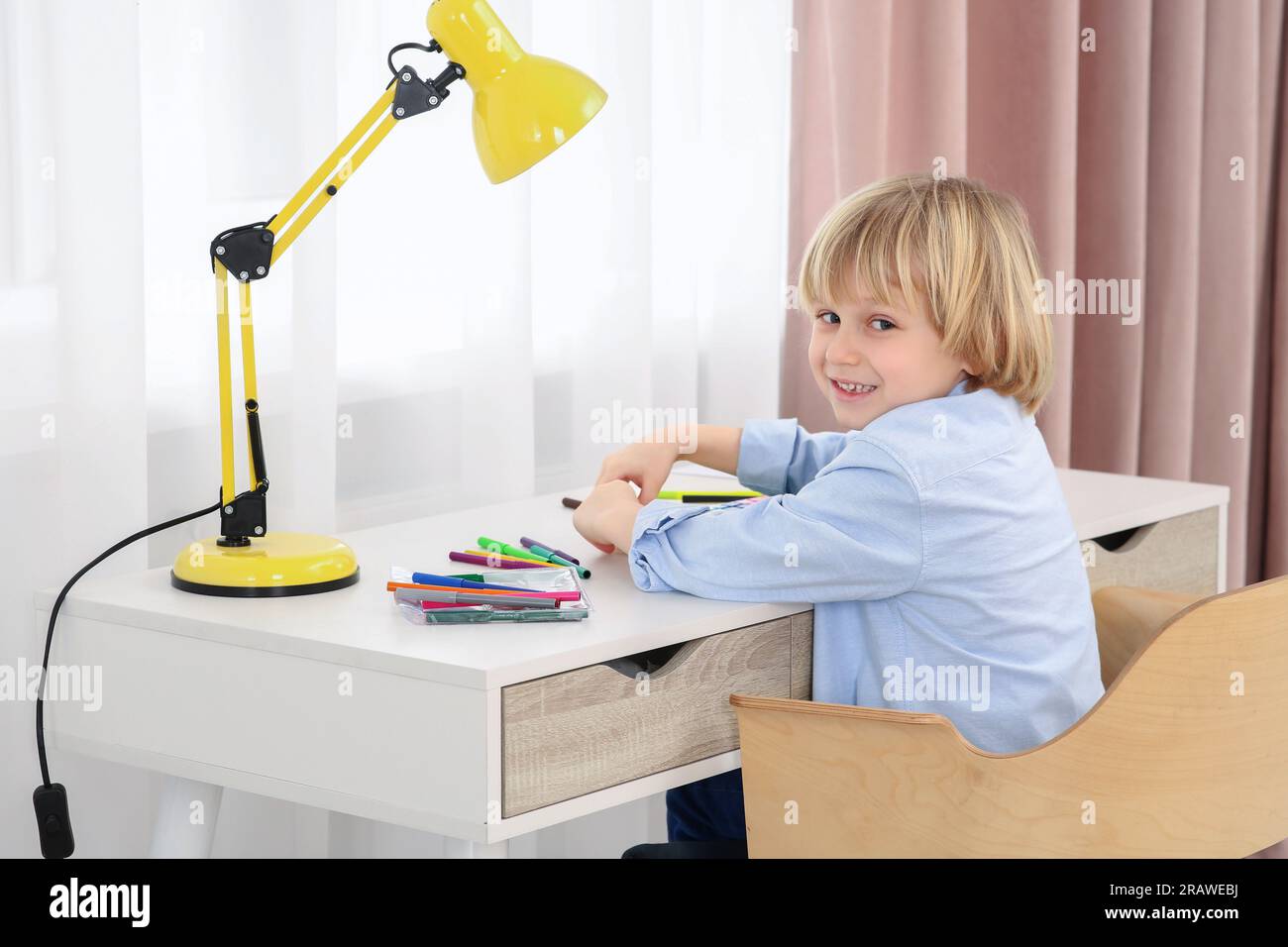 Boy sitting at desk hi-res stock photography and images - Alamy