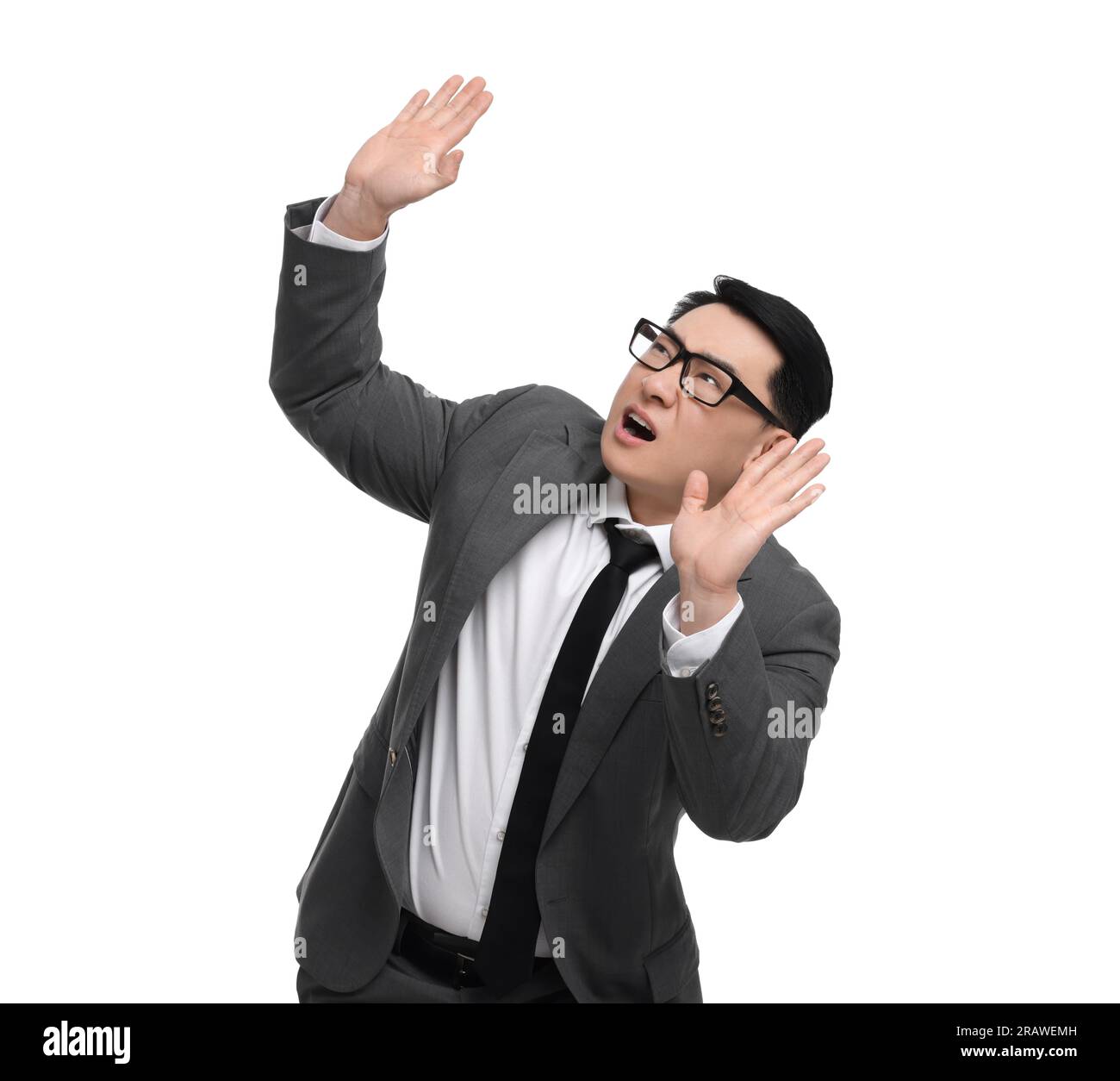 Scared businessman in suit posing on white background Stock Photo - Alamy