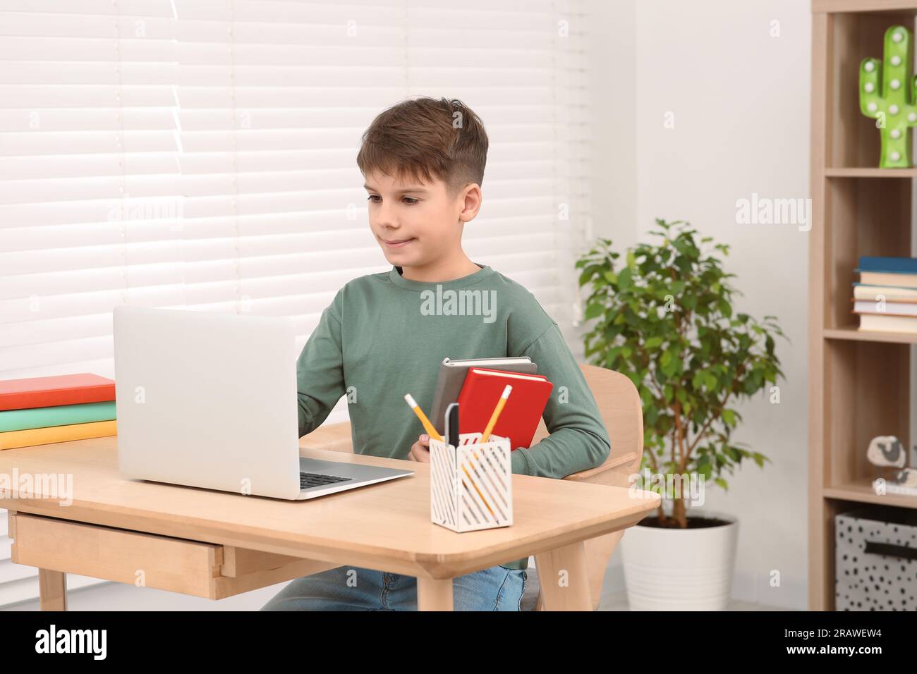 Boy studying books desk hi-res stock photography and images - Alamy