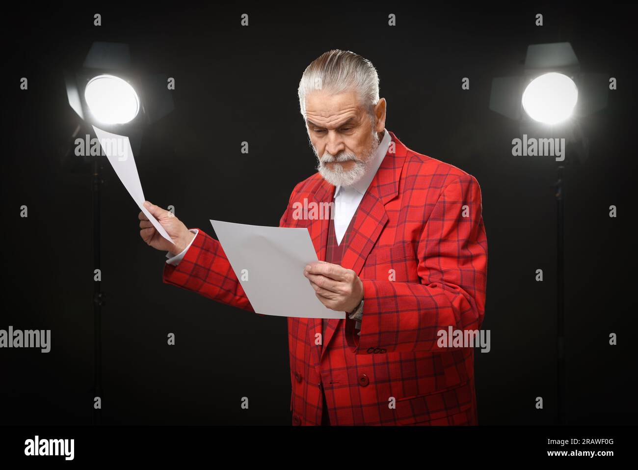 Senior actor with script performing on stage Stock Photo - Alamy