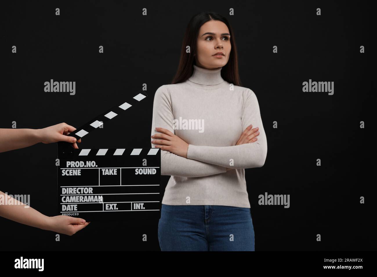 Actress performing while second assistant camera holding clapperboard ...