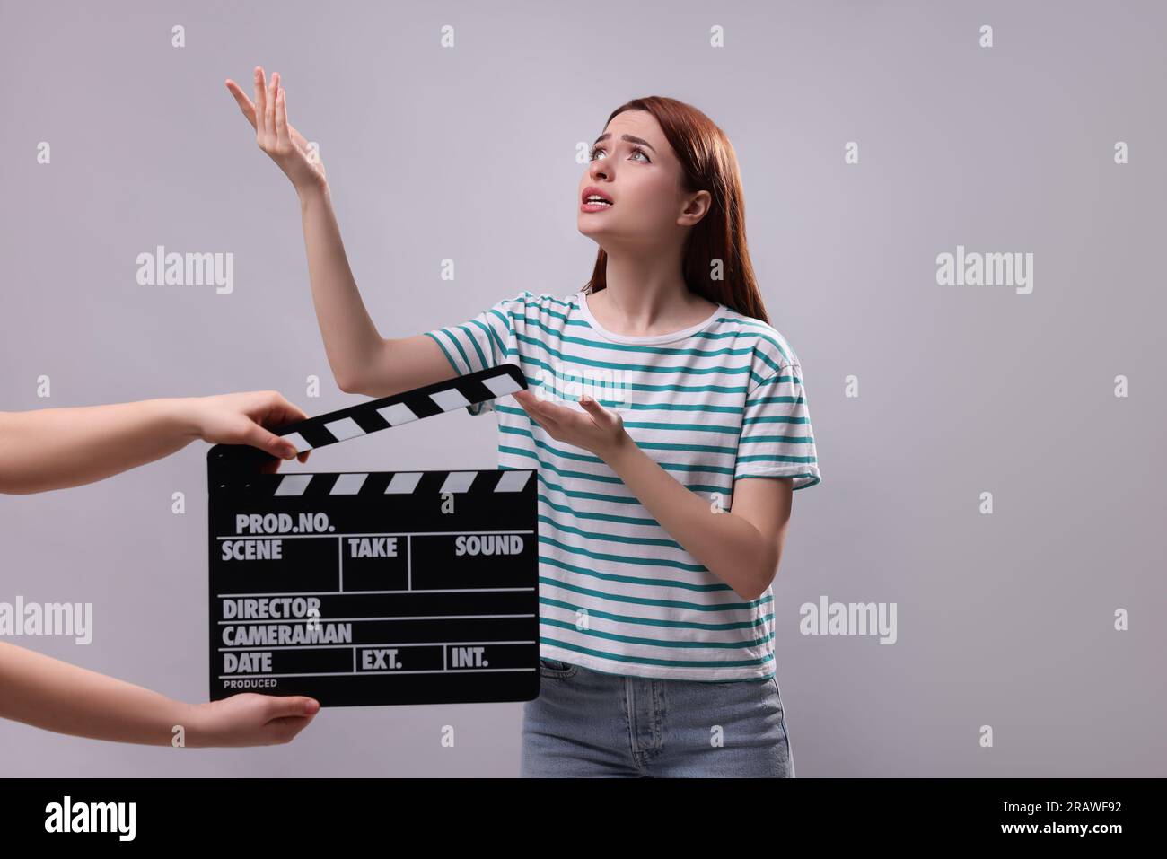Emotional actress performing role while second assistant camera holding ...