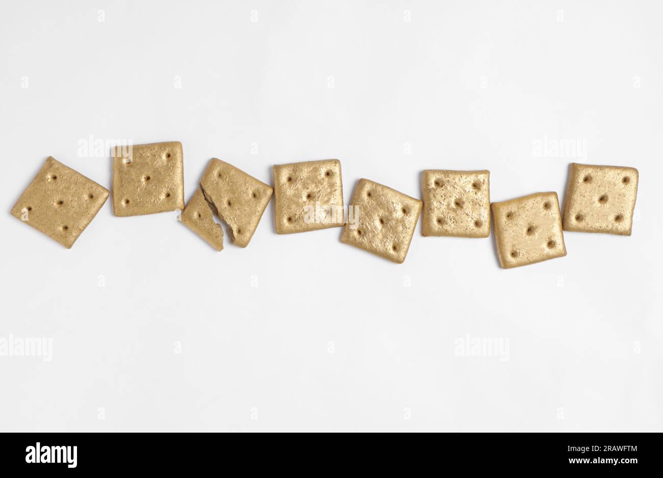 Shiny golden crackers on white background, top view Stock Photo - Alamy
