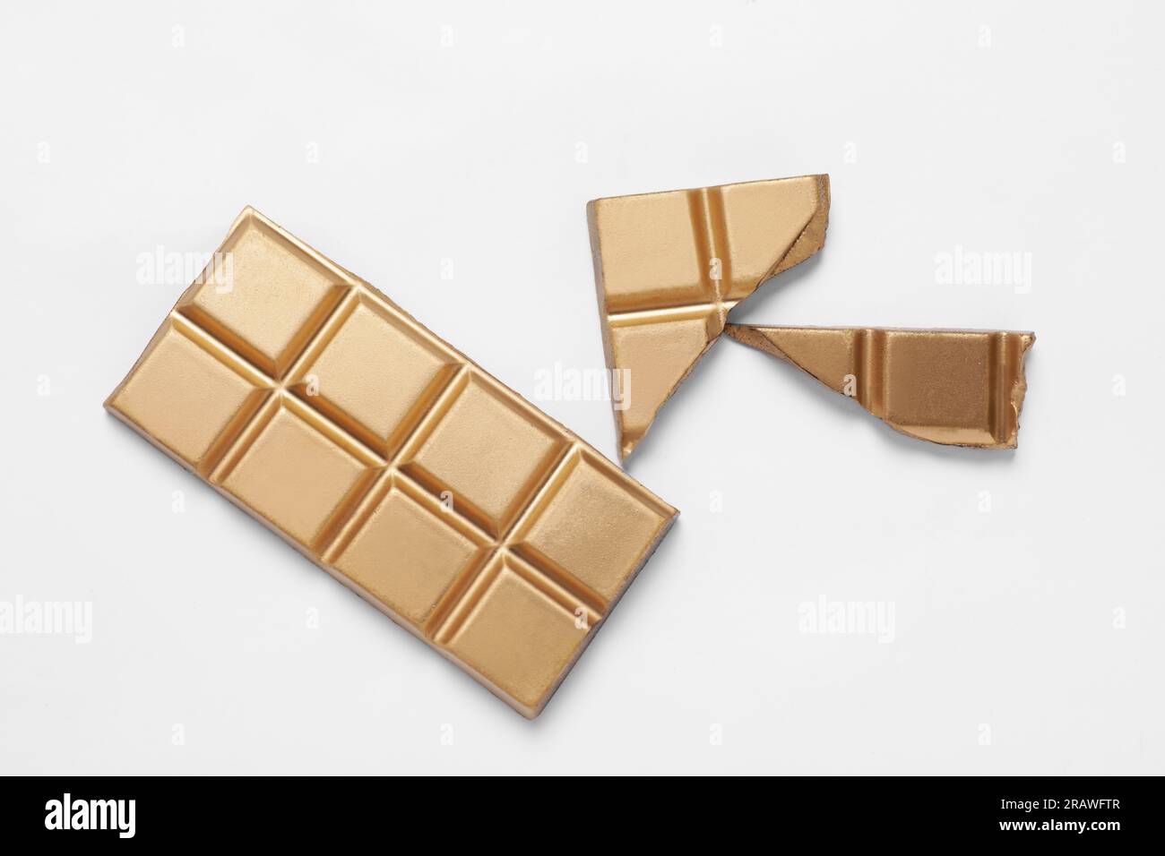 Shiny golden chocolate bar on white background, top view Stock Photo ...