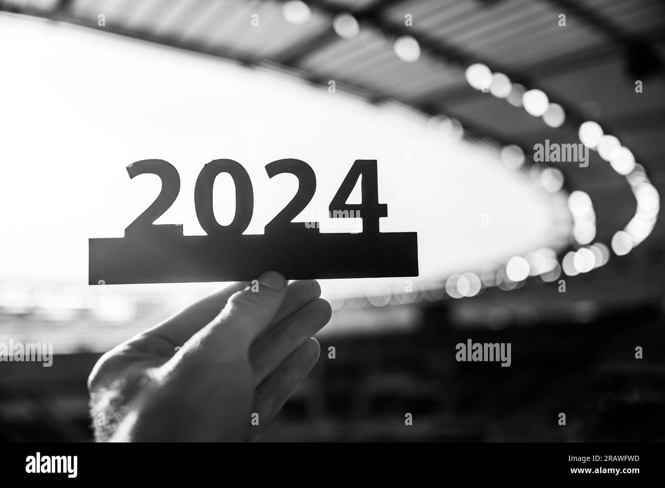 Silhouette of '2024' Holding in hand by Athlete. Sign Signals the Start ...