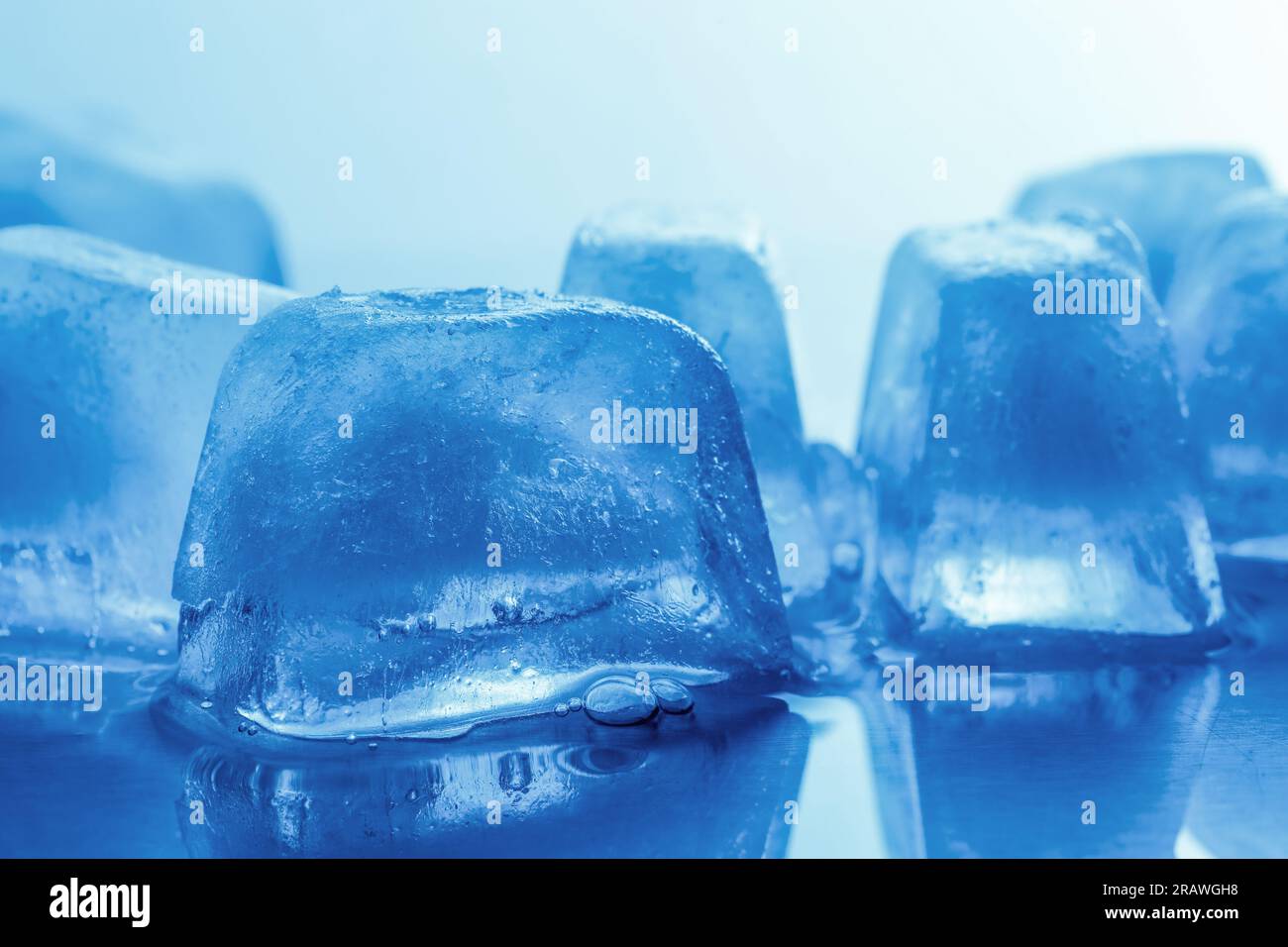 Crystal clear ice cubes on light blue background, closeup. Color tone effect Stock Photo - Alamy