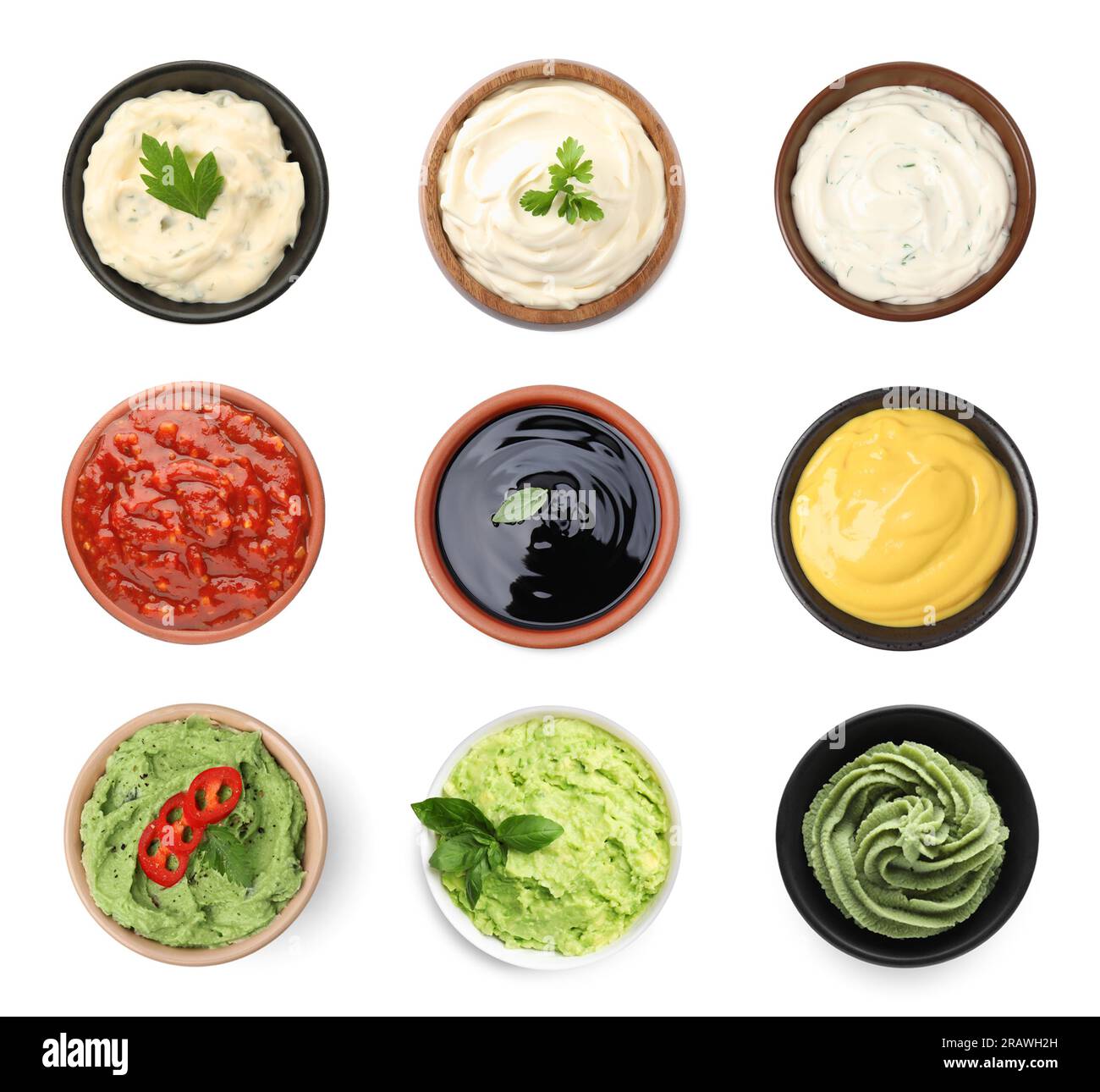 Set of guacamole and different sauces on white background, top view ...