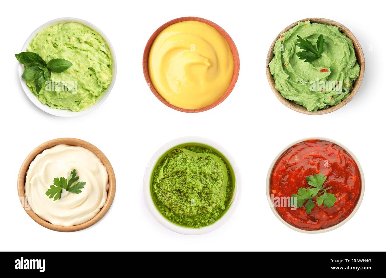 Set of guacamole and different sauces on white background, top view ...