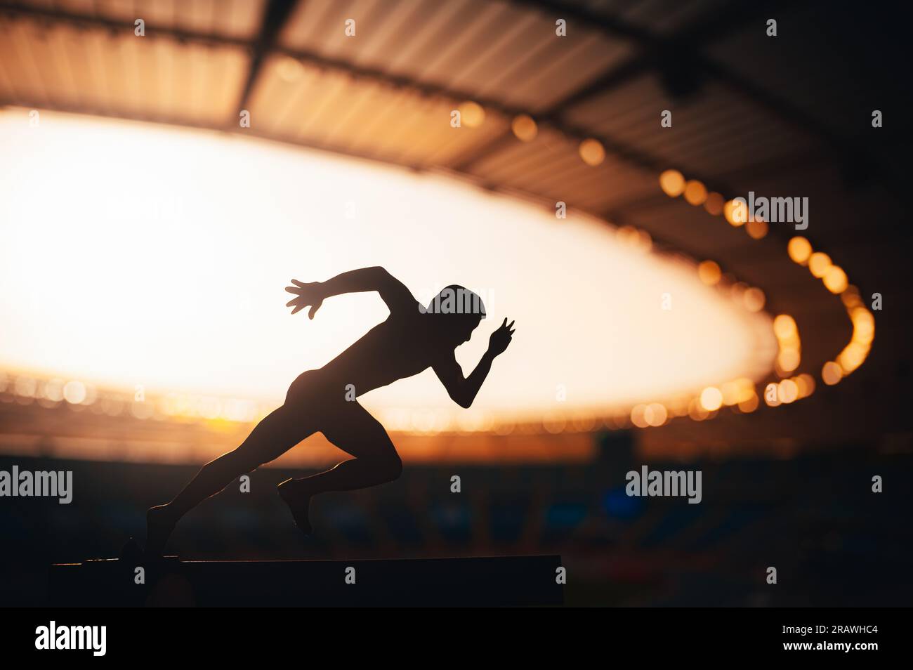 Chasing Glory: Silhouette of an Athlete, Primed for Speed, Standing ...