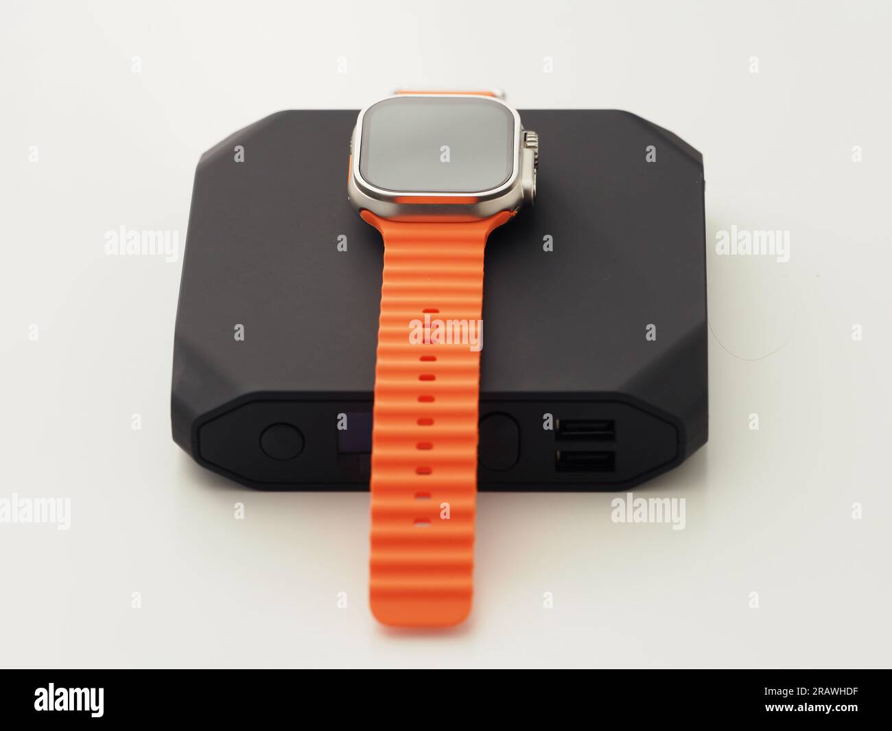 Smart watch on charging wireless from power bank Stock Photo - Alamy