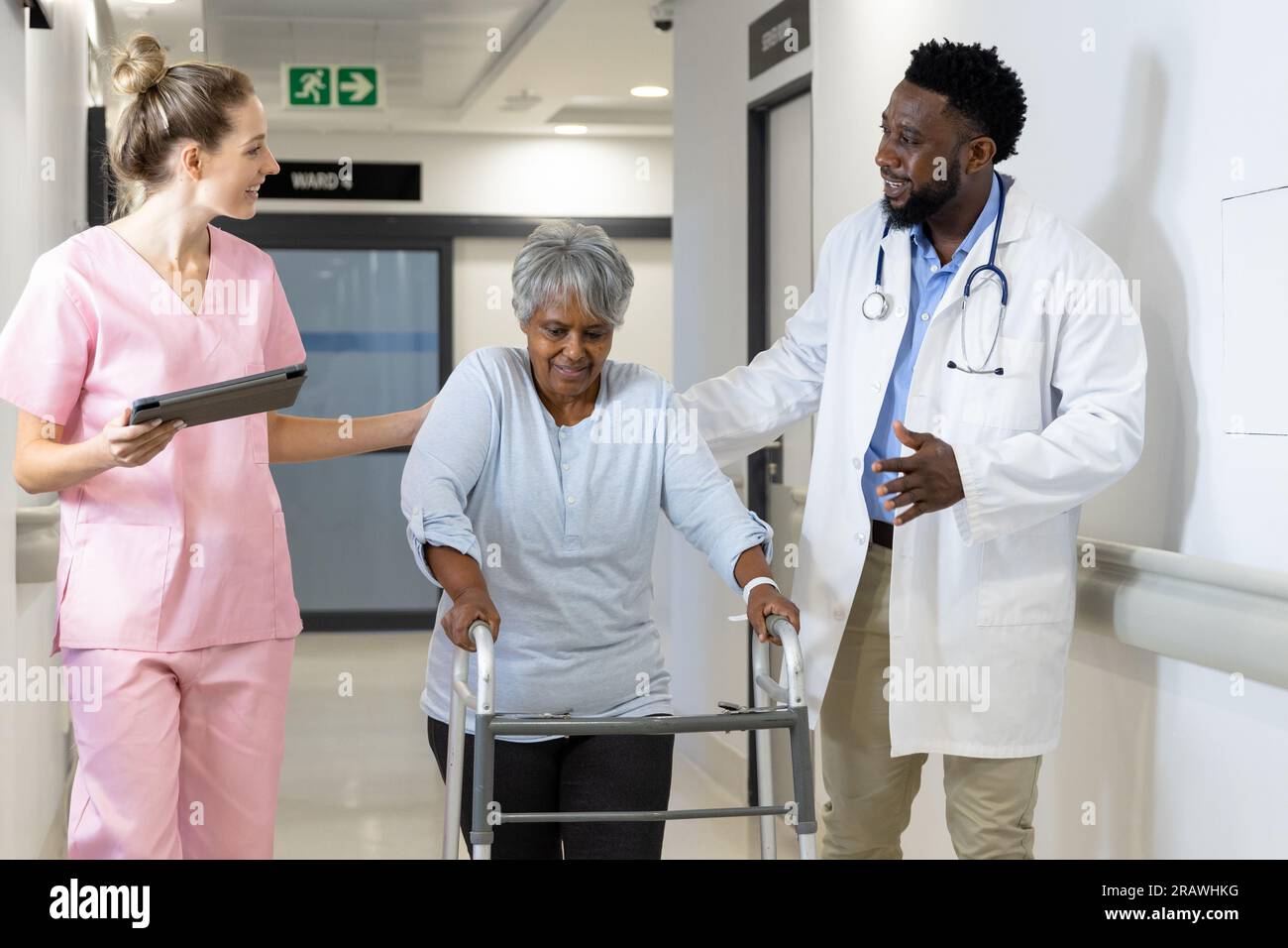 Diverse doctors and senior female patient with walking frame, walking ...