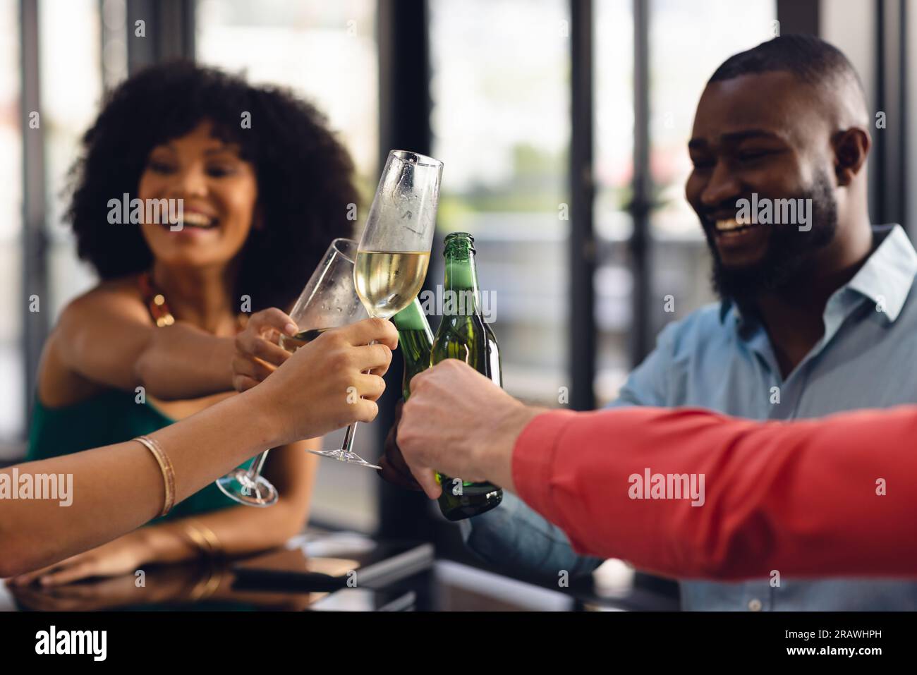 Happy diverse business colleagues drinking beer and champagne, making a ...