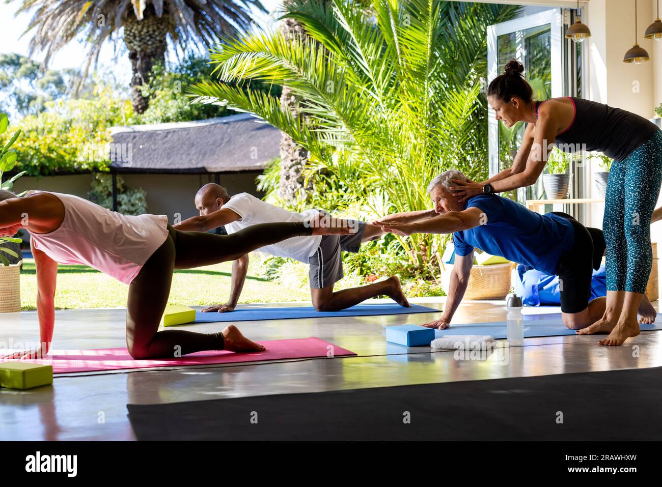 Senior diverse people with caucasian female teacher exercising in ...