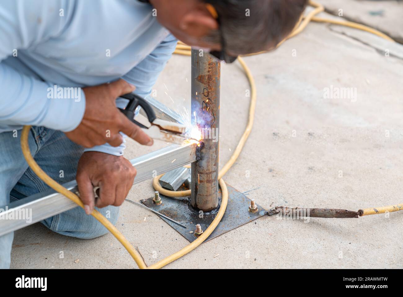 Construction Workers withe out safety gear welding steel bar in an ...