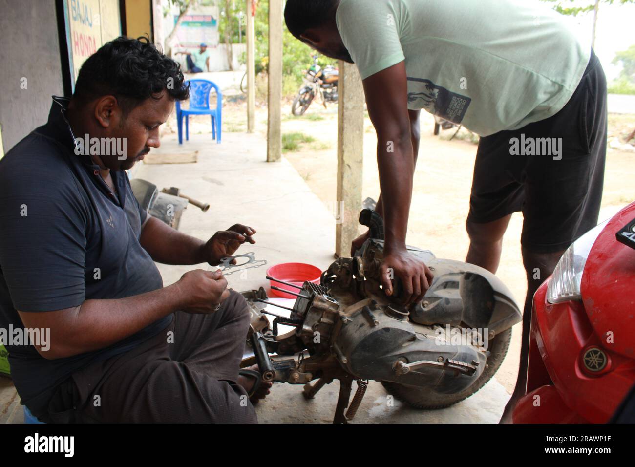 Mechanic Repairs a motercycle. A man works as a mechanic at a local ...