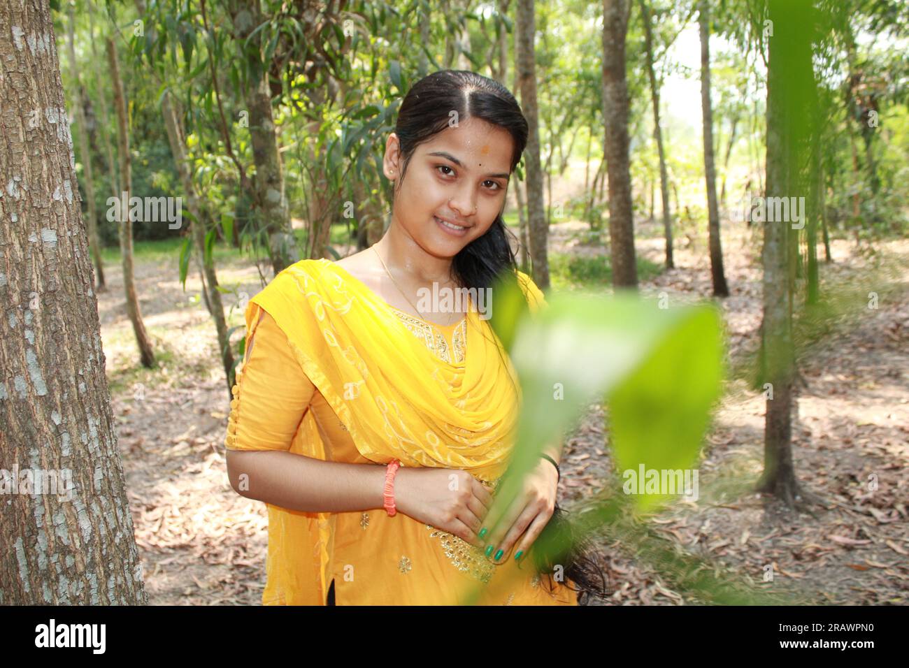 Portrait of a Indian girl standing behind tree Stock Photo - Alamy