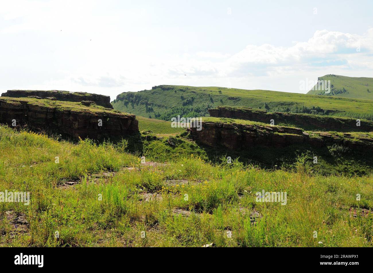 The remains of an ancient stone wall running along the top of a hill in ...