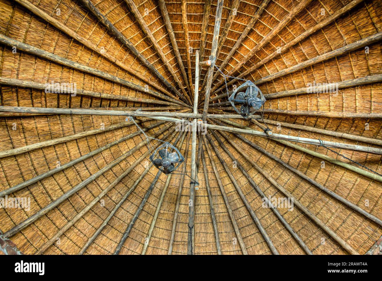 thatched roof circular with large wooden beams and vintage industrial ...