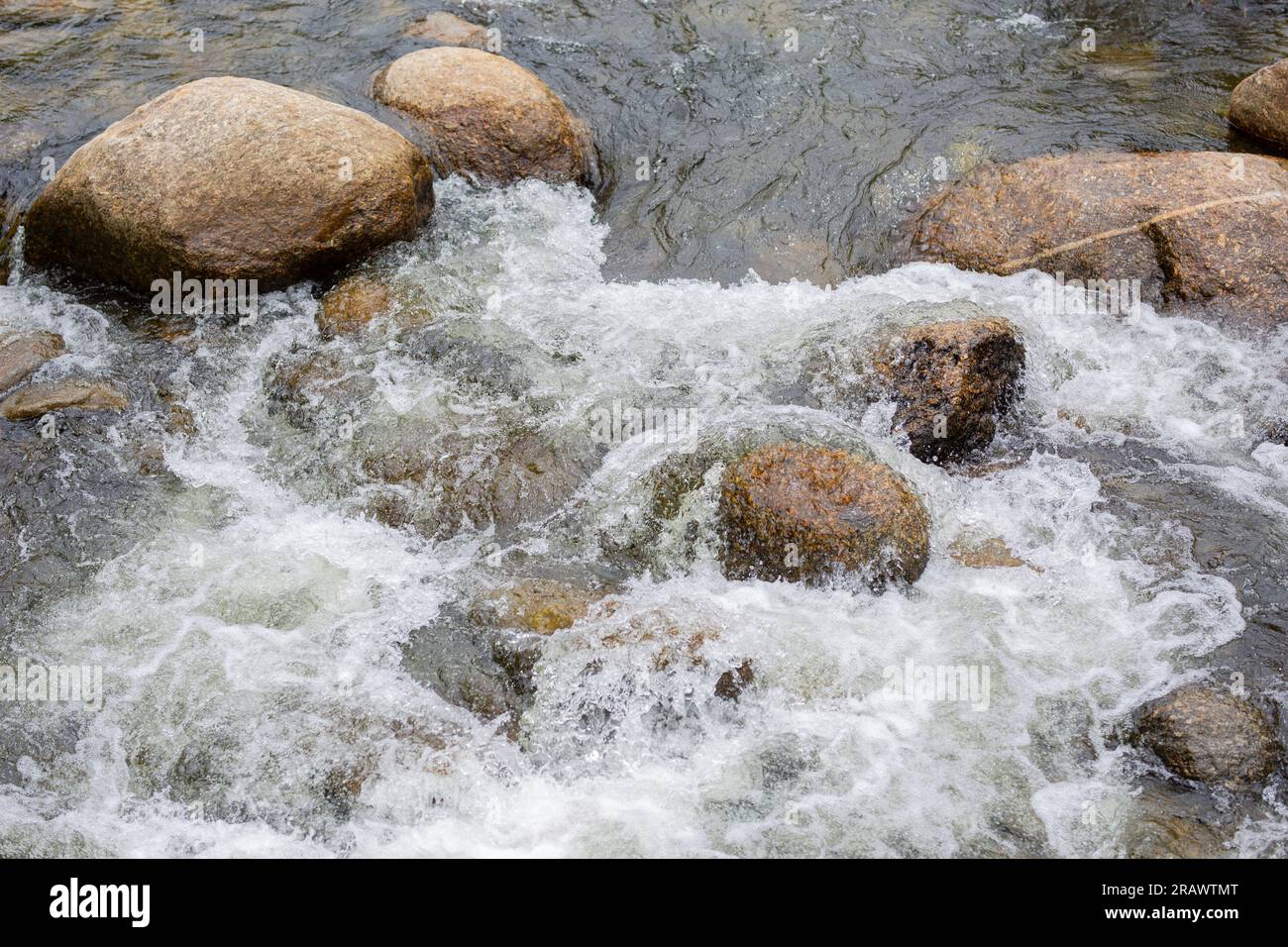 The flow of water in the waterfall stream crashes through the rocks ...