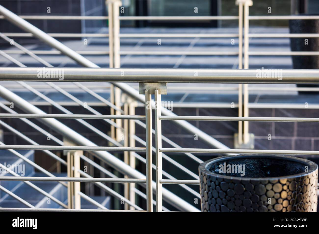 modern stainless steel balustrade on a staircase tiled with gray ...
