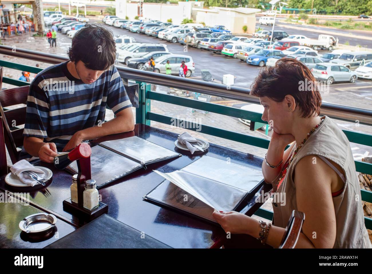 mother and son, having lunch at a terrace on the first floor parking ...