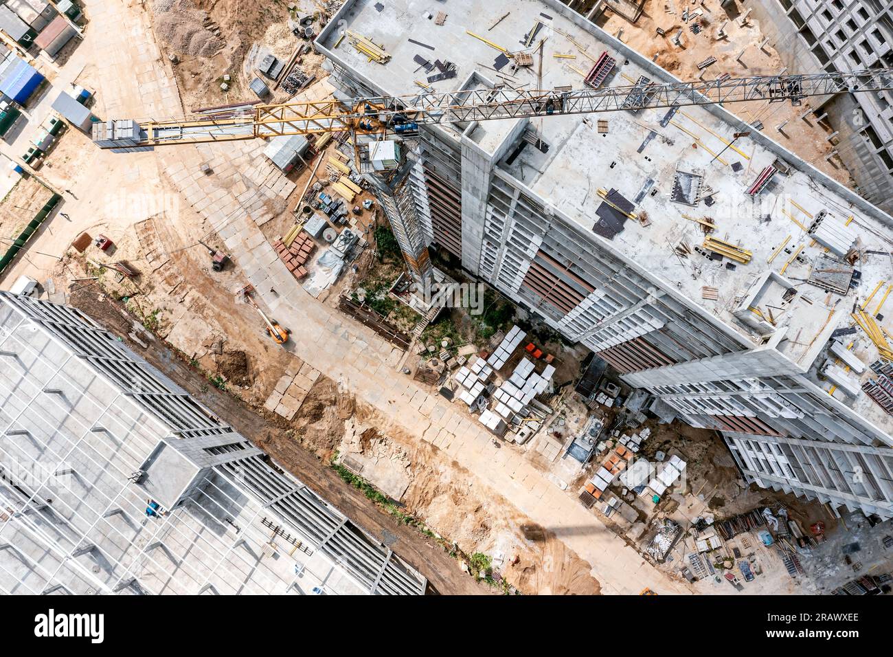 construction site with high-rise apartment buildings and working crane ...