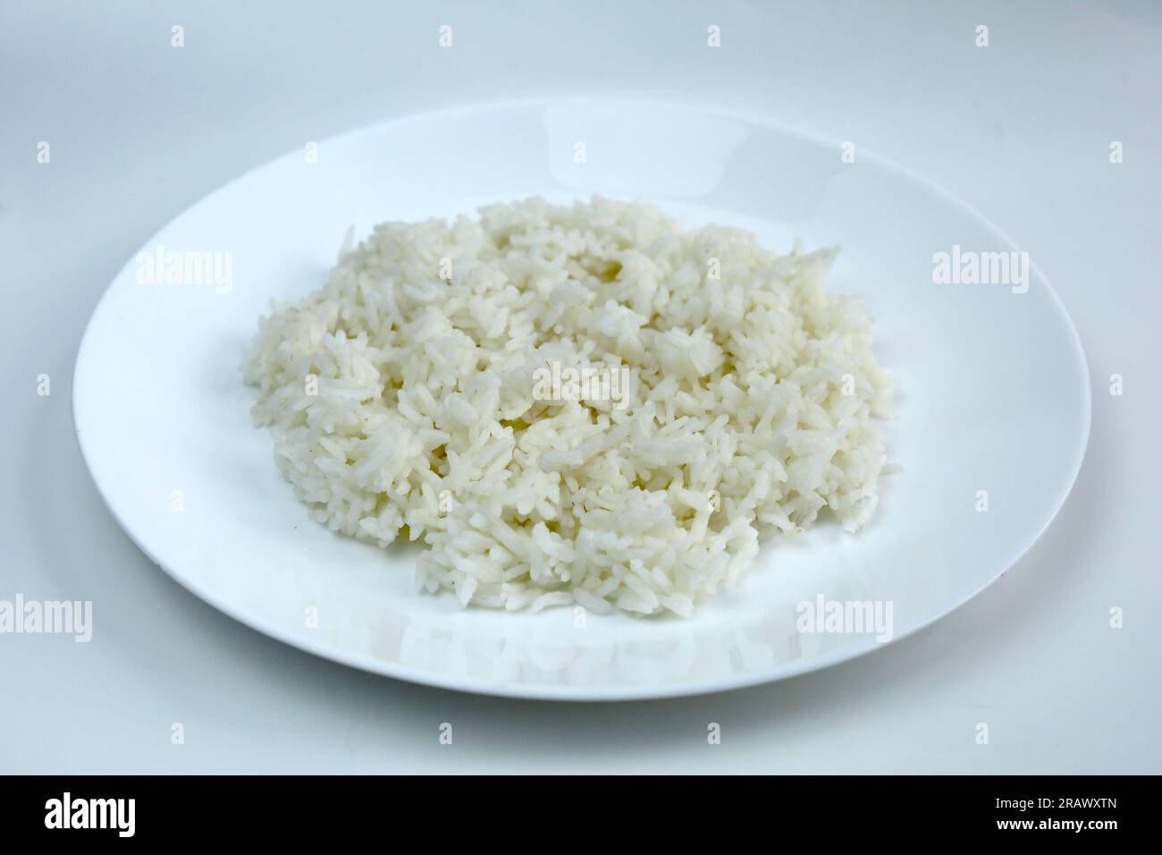 Cooked white rice on a plate and isolated on white background Stock ...