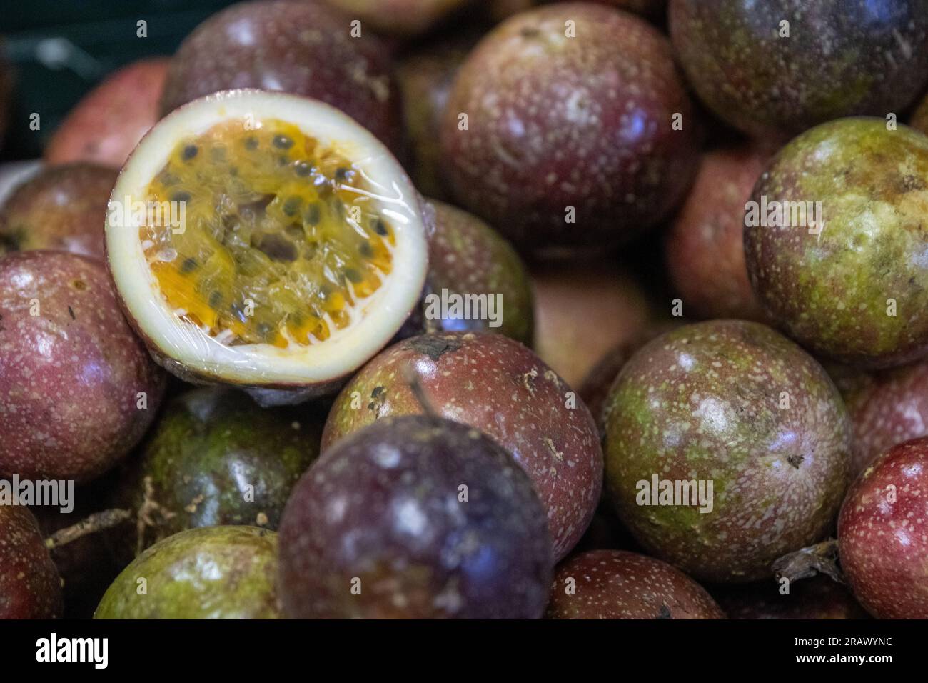Passionfruit sliced on display on a grocery rack Stock Photo - Alamy